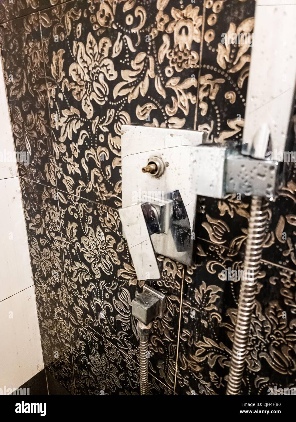 Broken stainless steel shower lever in a bathroom Stock Photo - Alamy