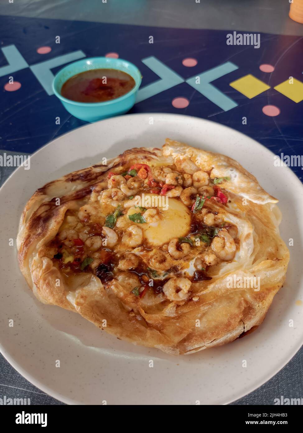 "roti sarang burung" or pratha looks like bird nest with half cook eggs ...