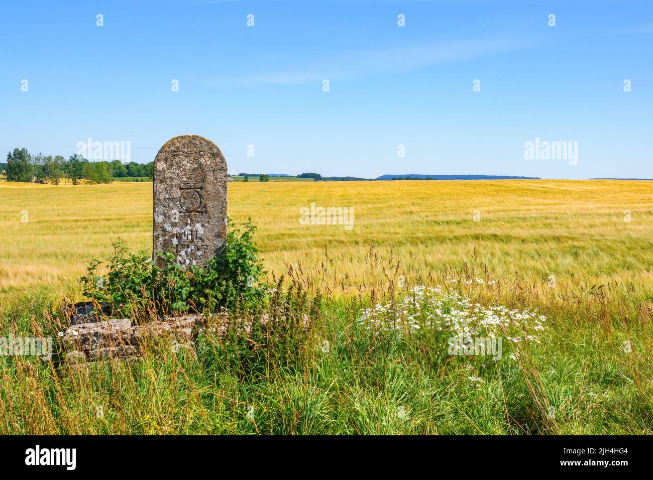 Milestone at the roadside in a rural landscape Stock Photo - Alamy