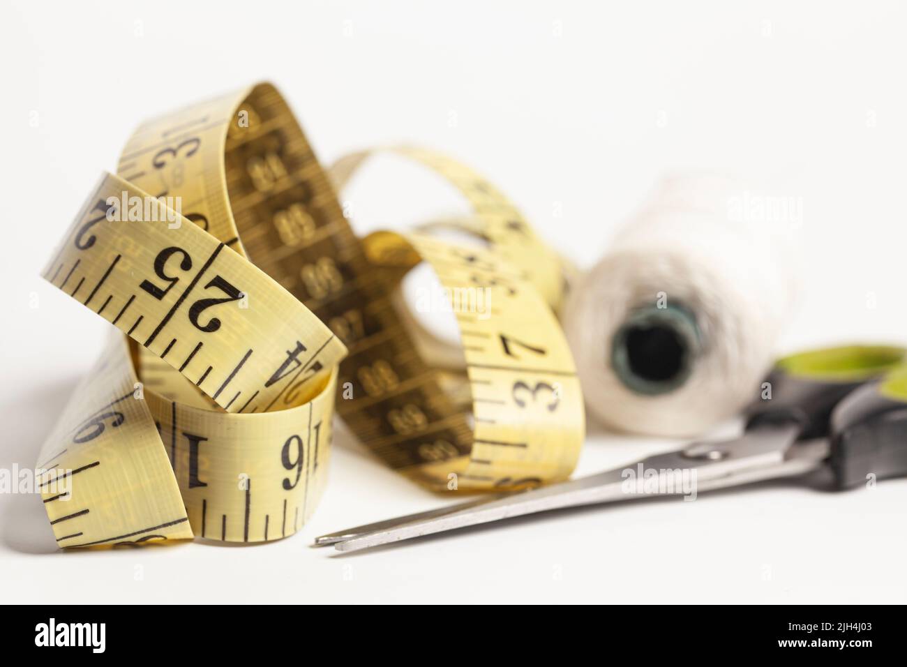 Sewing utensils, scissors, threads, measuring tape isolated on white ...