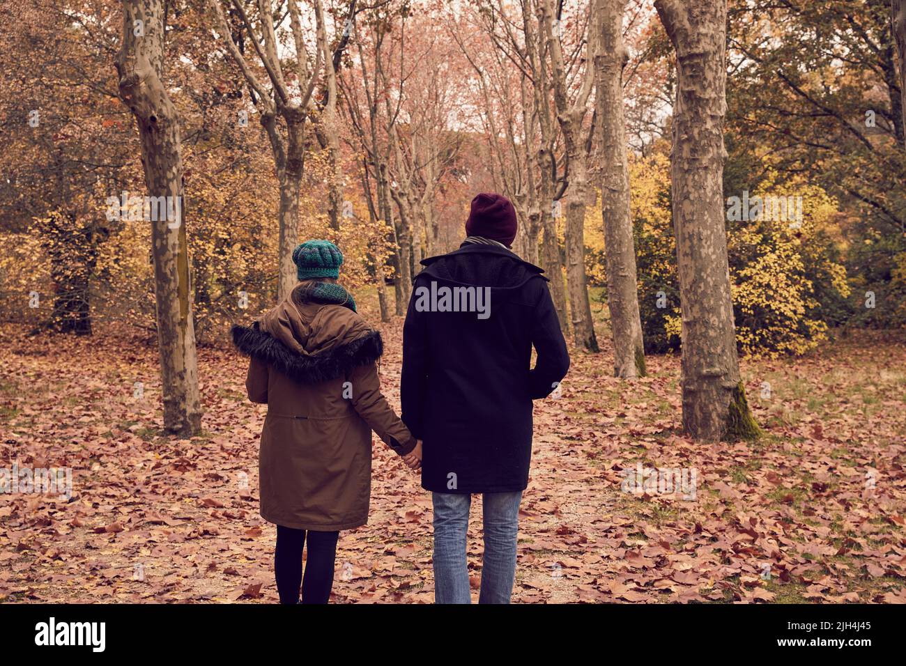 Young white Caucasian couple walking backwards holding hands strolling ...