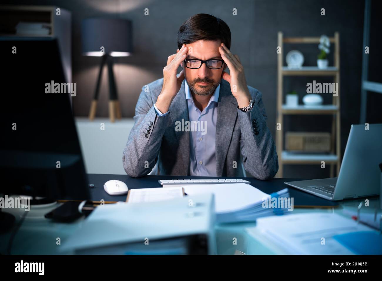 Stressed Tax Advisor With Headache. Sad Accountant Stock Photo - Alamy