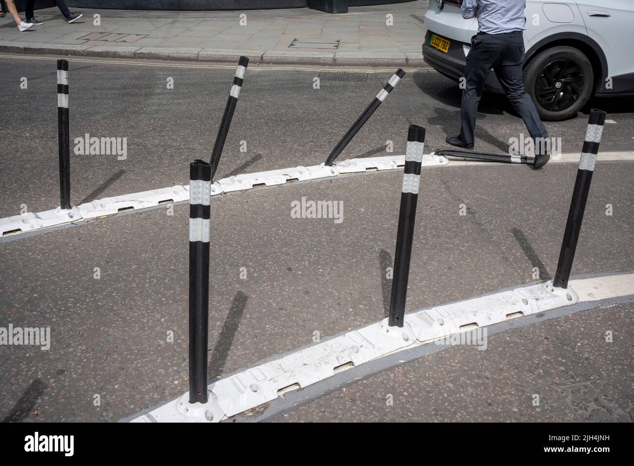 A sequence of leaning posts, from the first in an upright position to ...