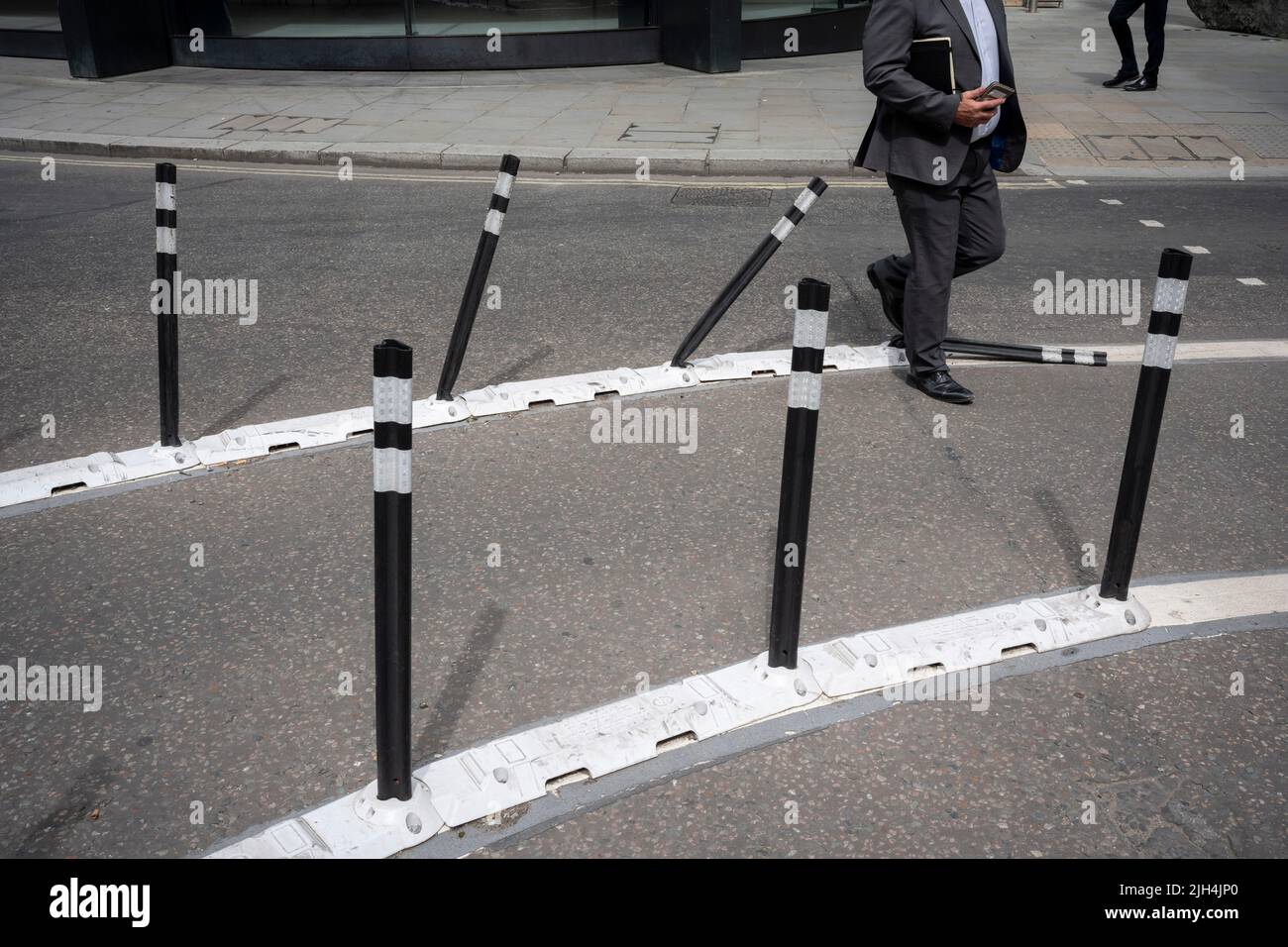 A sequence of leaning posts, from the first in an upright position to ...