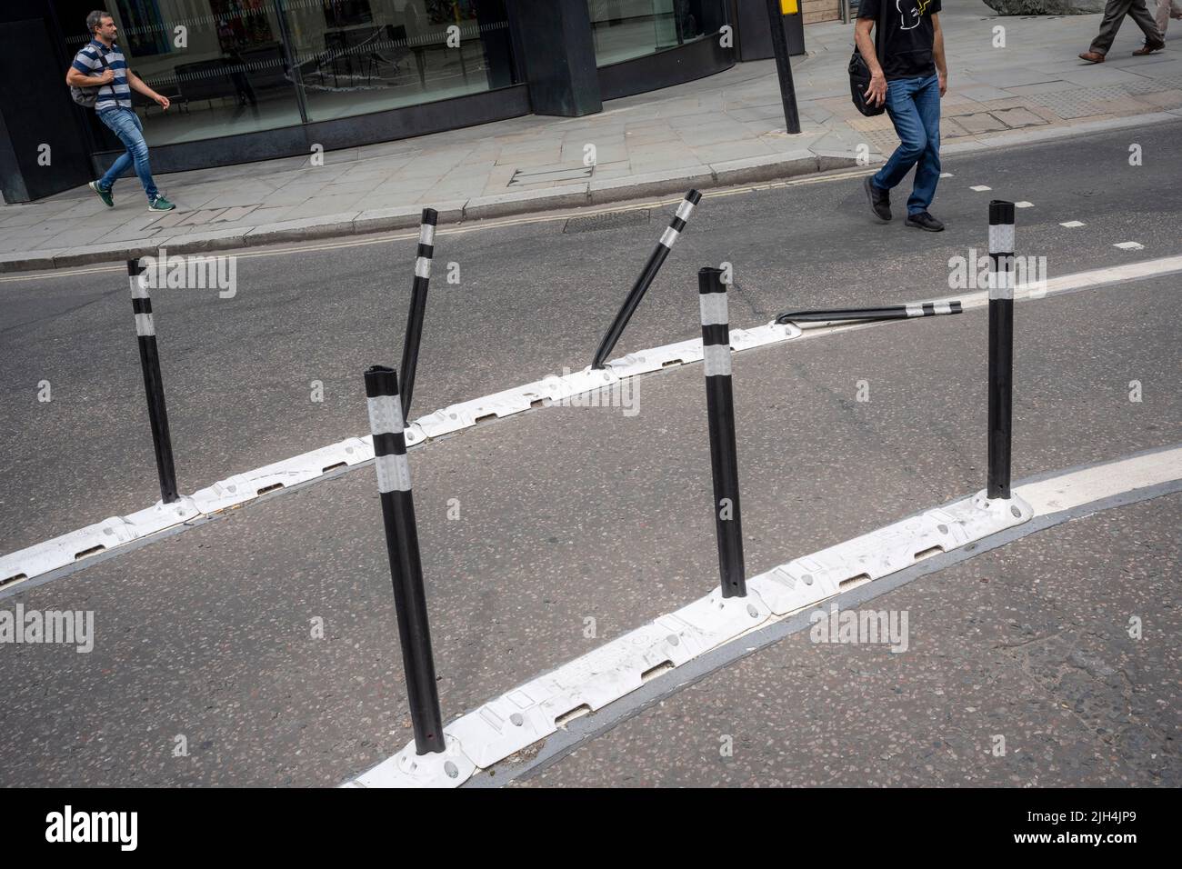 A sequence of leaning posts, from the first in an upright position to ...