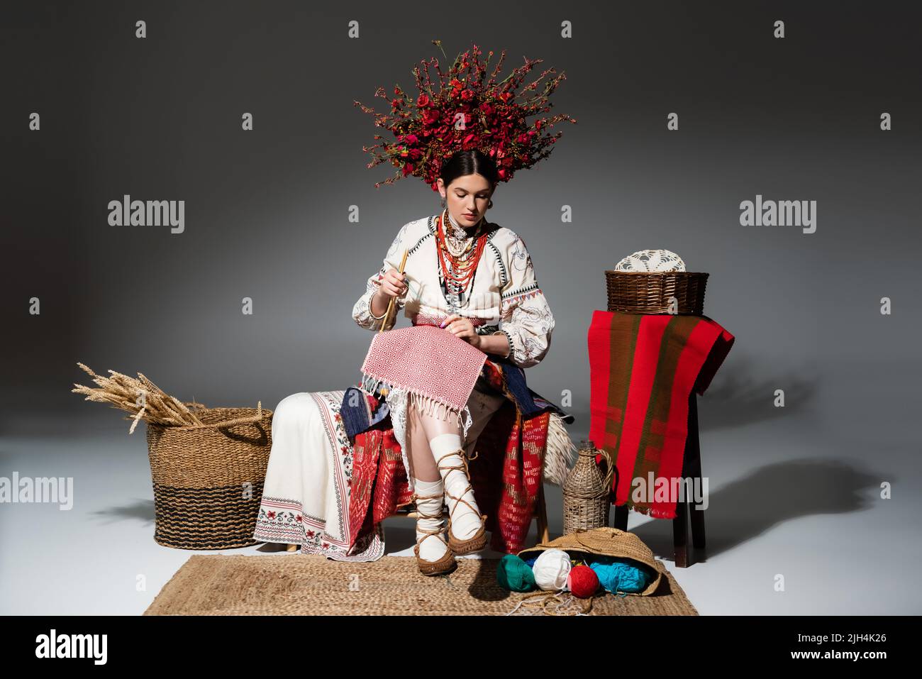 full length of ukrainian woman in traditional clothes and red floral ...