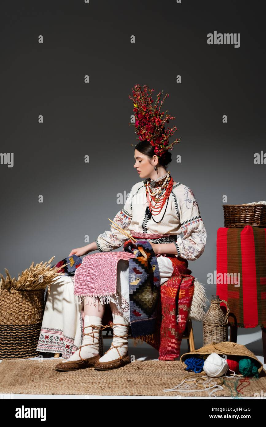 full length of ukrainian woman in traditional clothes and red wreath ...