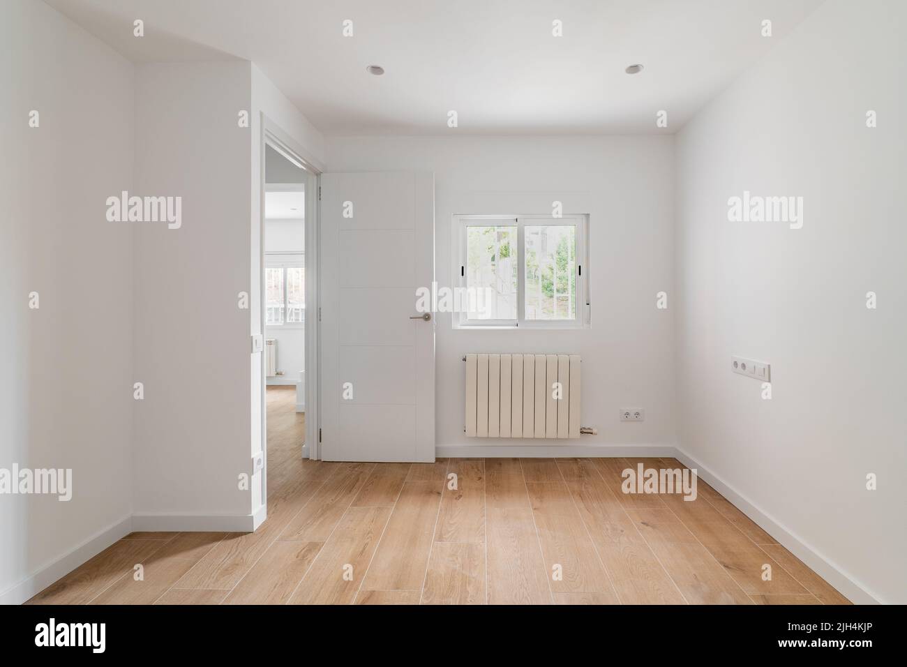 Empty white room with window and natural light. Interior of the freshly ...