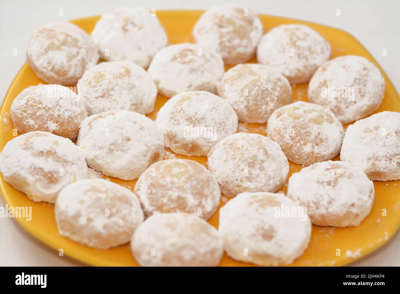 yellow plate of traditional Arabic cookies for celebration of Islamic ...