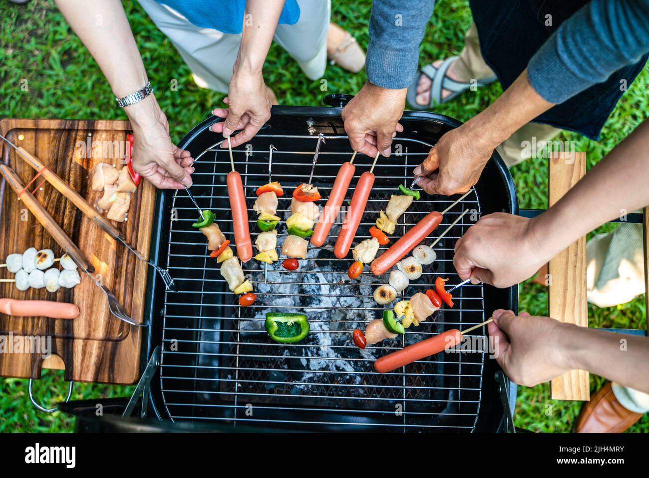 People hand grill BBQ in food party home garden happy friendship Stock ...