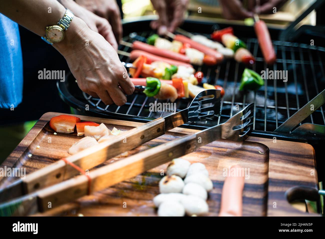 People hand grill BBQ in food party home garden happy friendship Stock ...