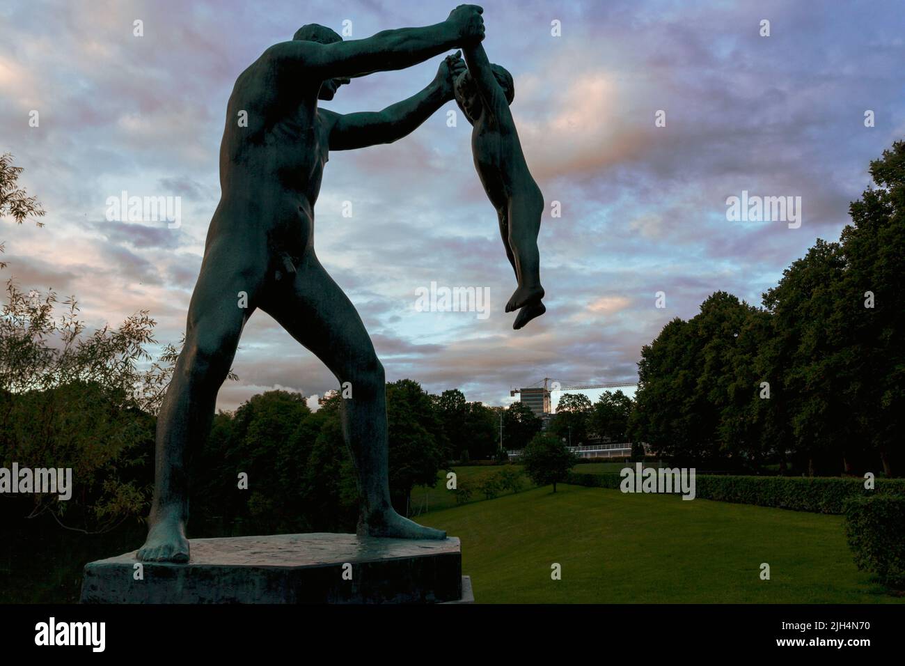 Bronze statues represent man playing with baby in a perfect dusk. Oslo ...