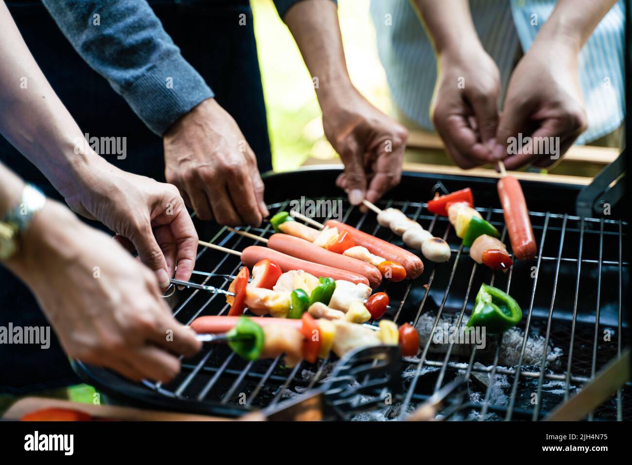 People hand grill BBQ in food party home garden happy friendship Stock ...