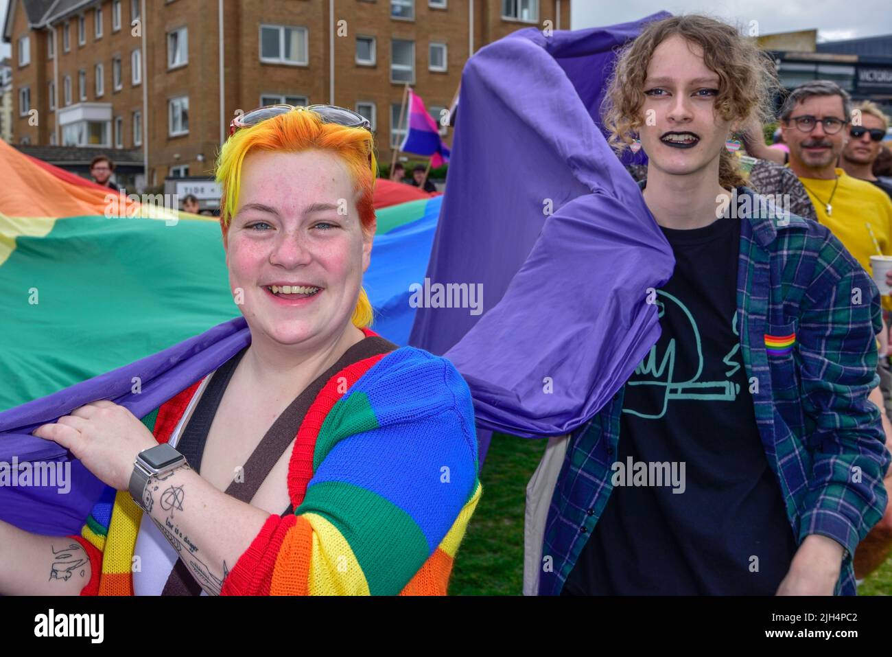 Happy participants in the vibrant colourful Cornwall Prides Pride parade in Newquay Town centre ...