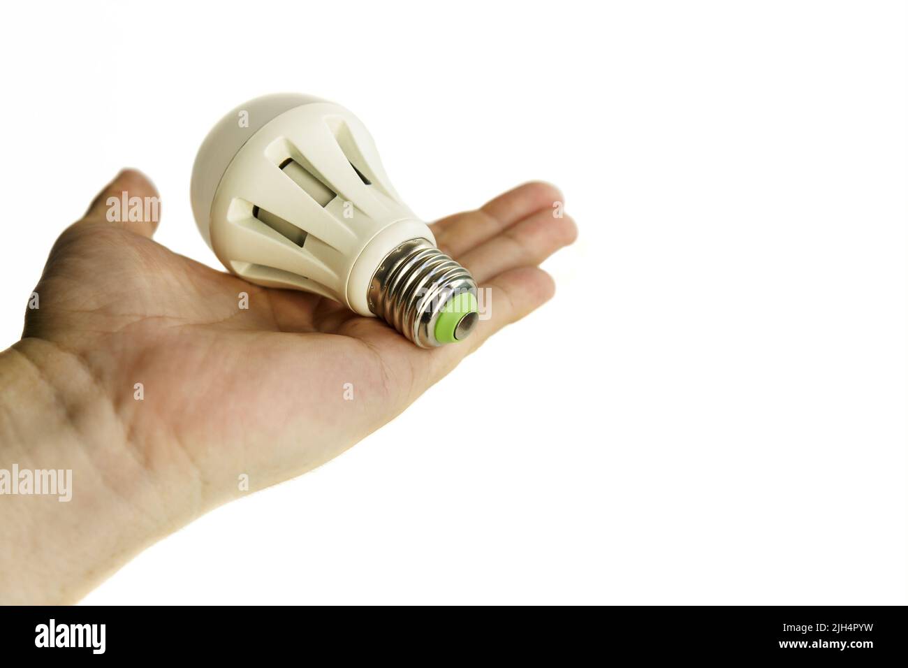 light bulb in hand. The LED light bulb lies in a man's hand. White ...