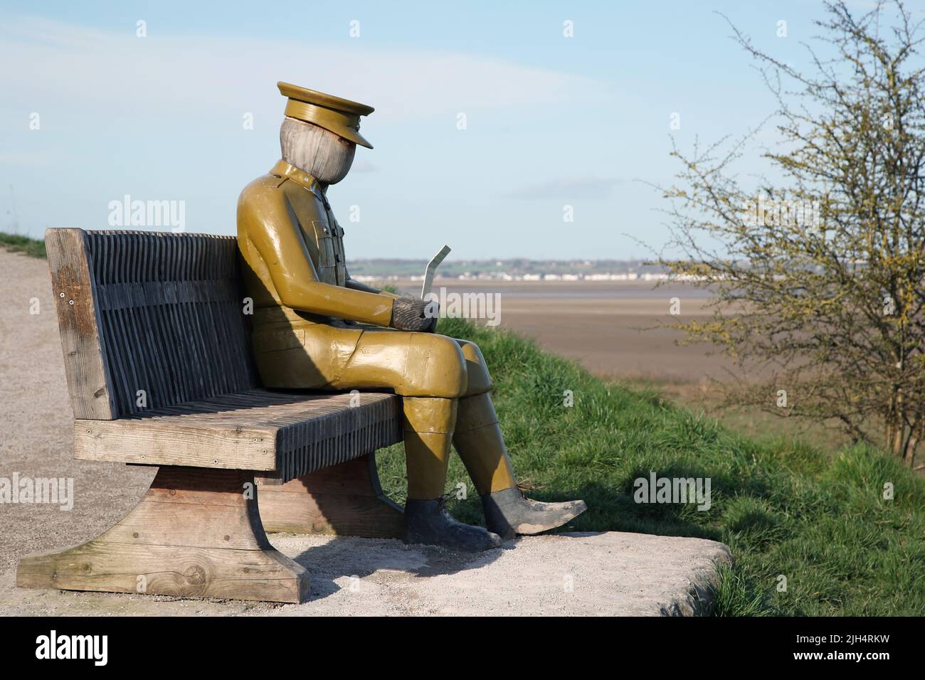 sculpture of World War 1 soldier reading letter seated on bench along ...