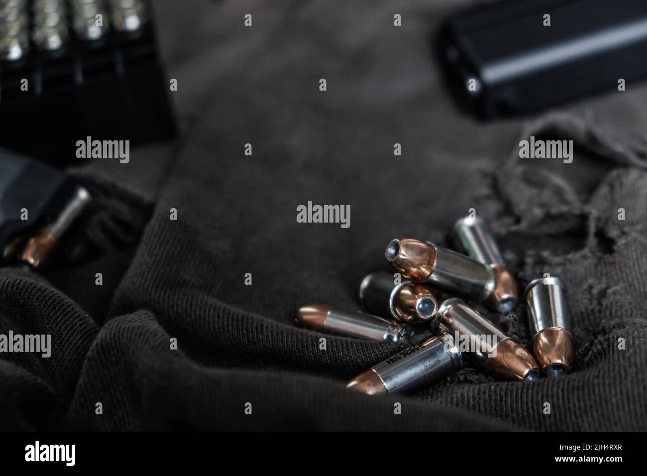 9mm conceal semi automatic gun with jacket hallow point bullet on cloth ...