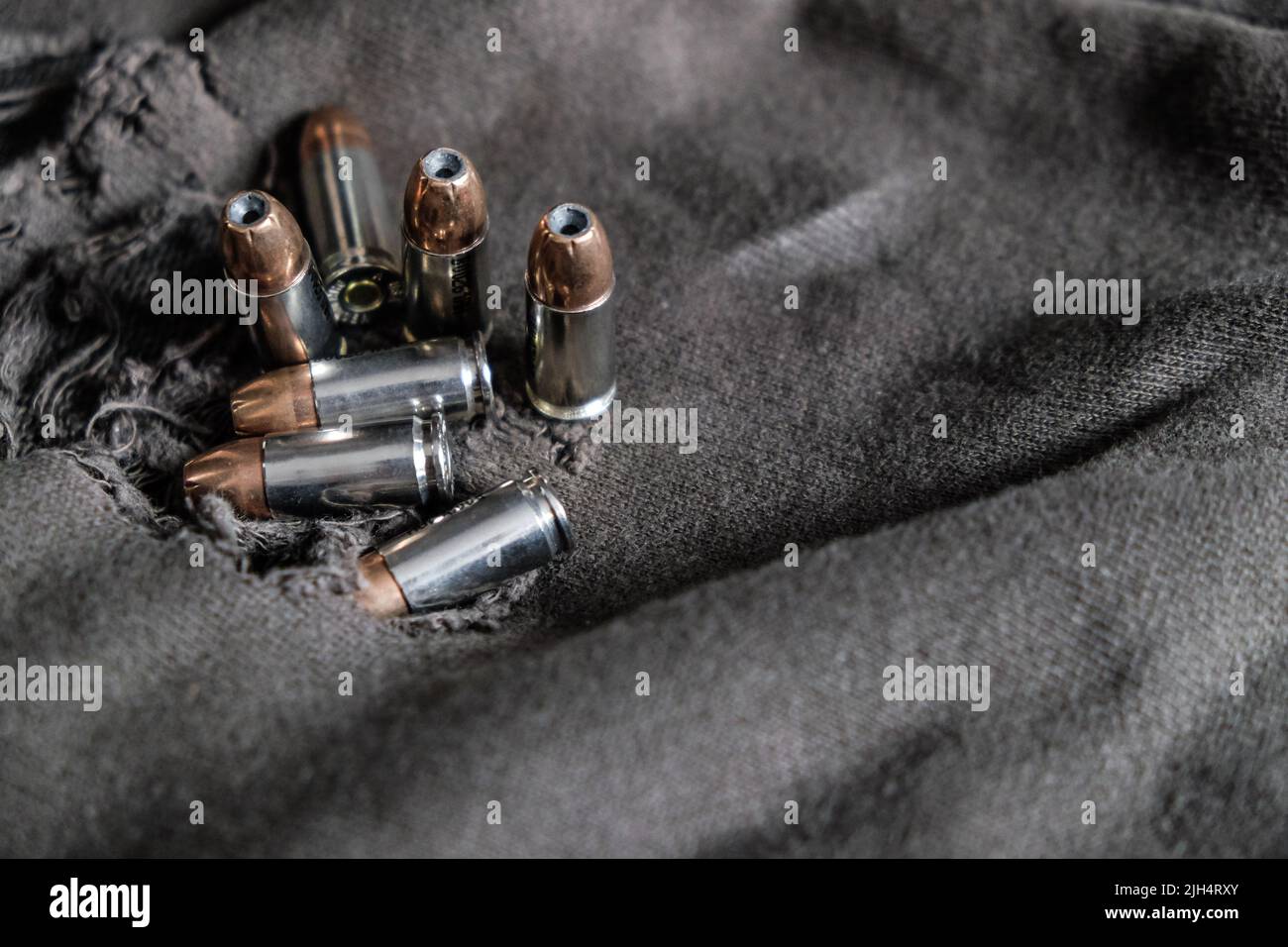 9mm conceal semi automatic gun with jacket hallow point bullet on cloth ...