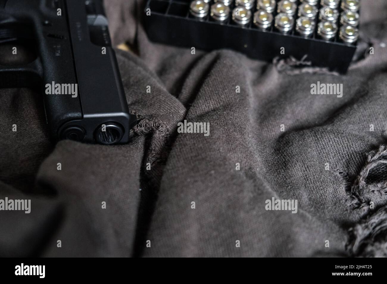 9mm conceal semi automatic gun with jacket hallow point bullet on cloth ...