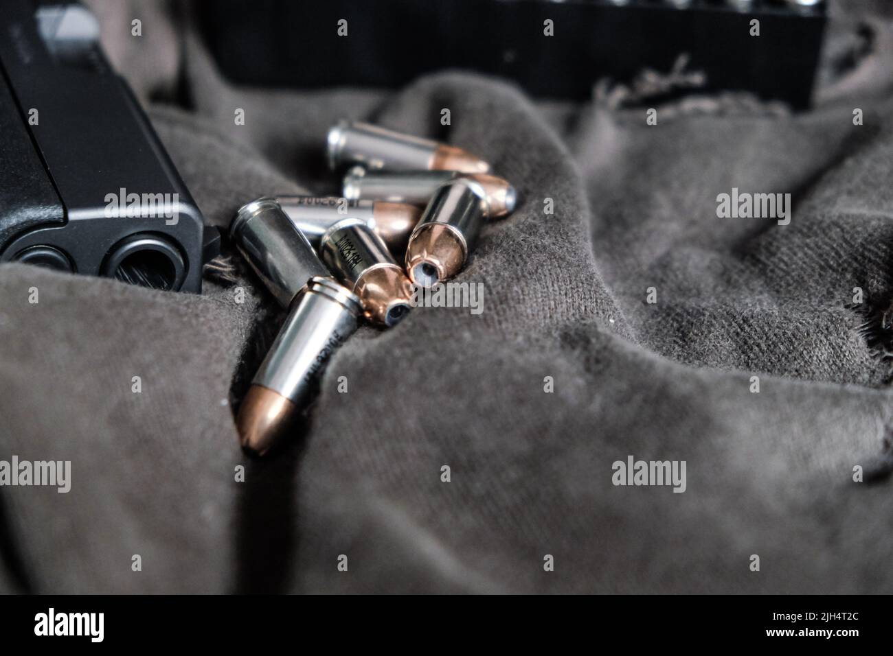 9mm conceal semi automatic gun with jacket hallow point bullet on cloth ...