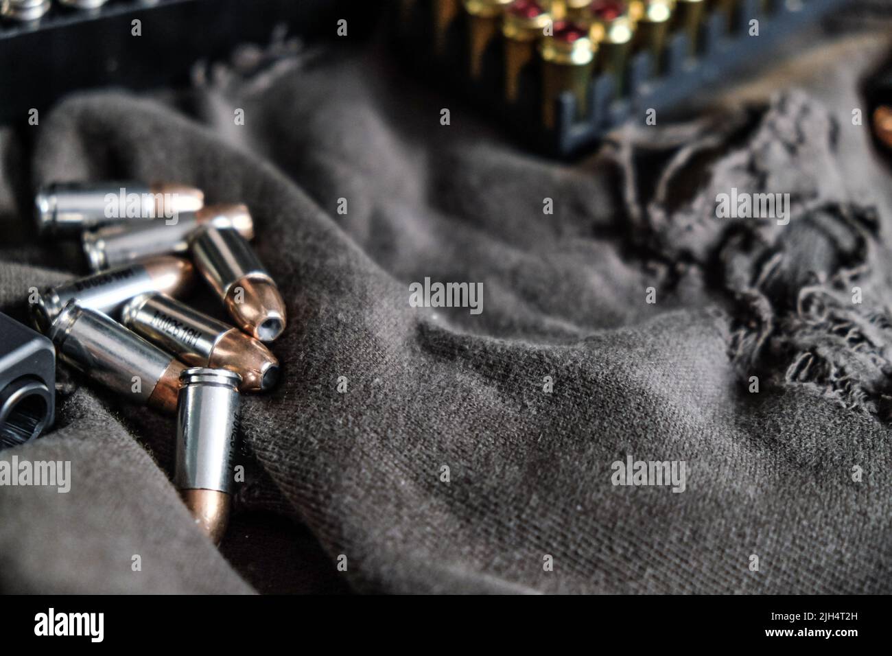 9mm conceal semi automatic gun with jacket hallow point bullet on cloth ...