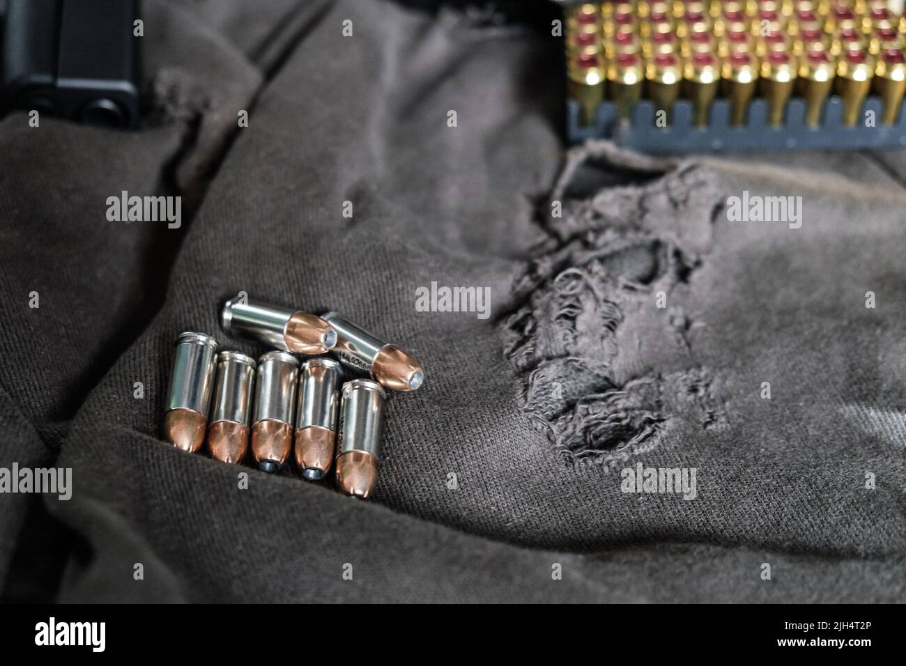 9mm conceal semi automatic gun with jacket hallow point bullet on cloth ...