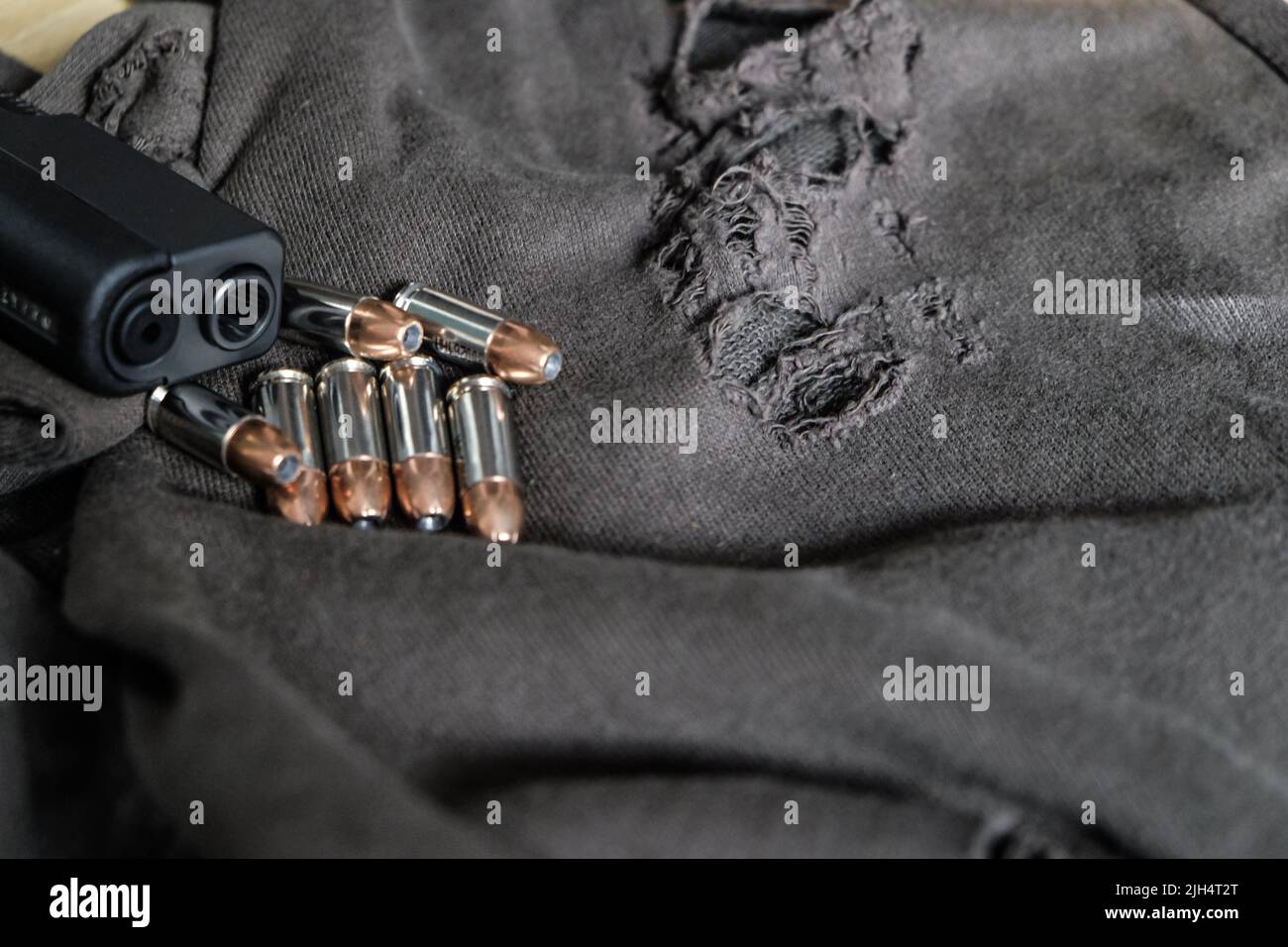 9mm conceal semi automatic gun with jacket hallow point bullet on cloth ...