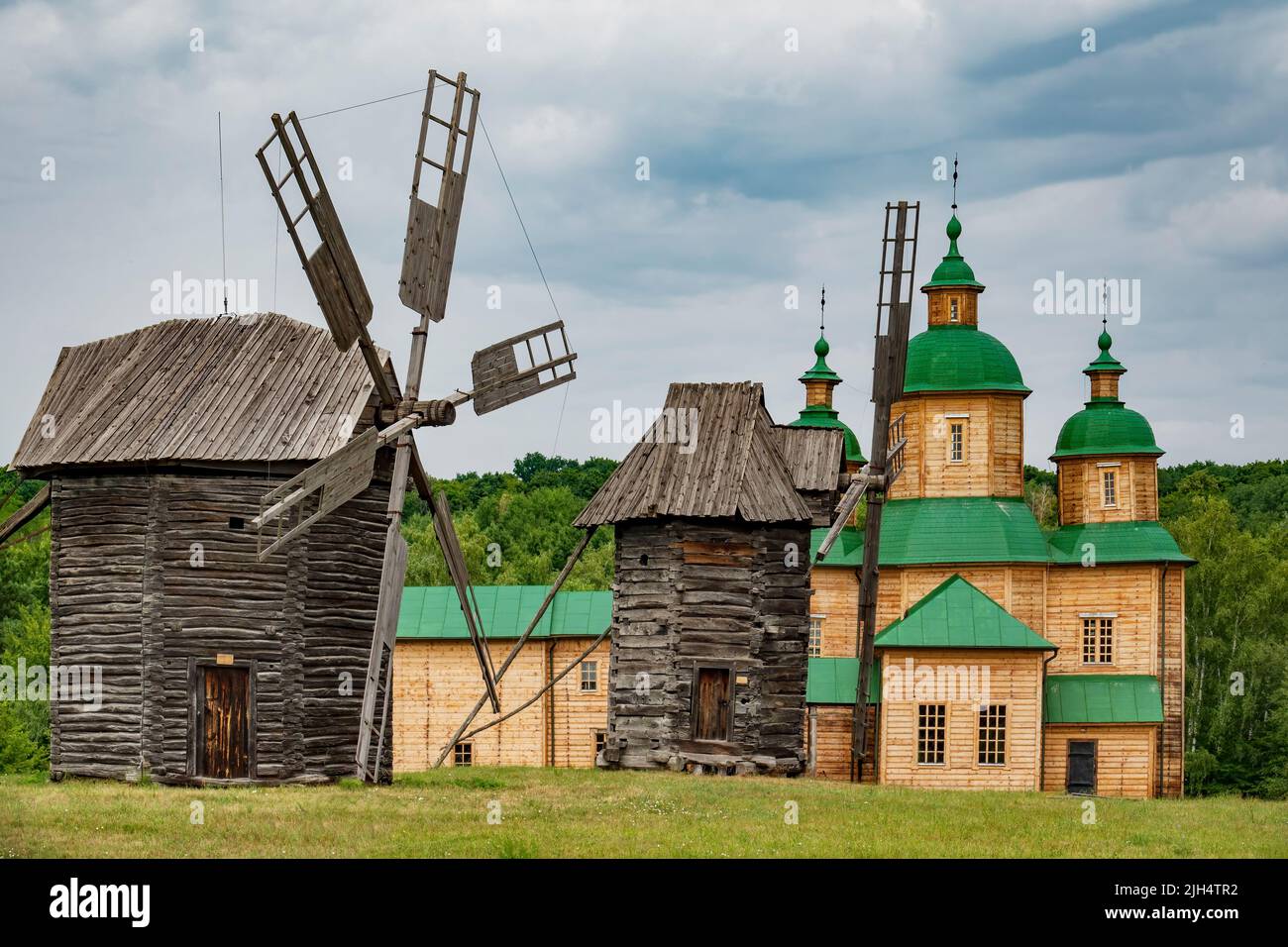Old wooden church and windmills in the Pirogovo skansen, Kyiv, Ukraine ...
