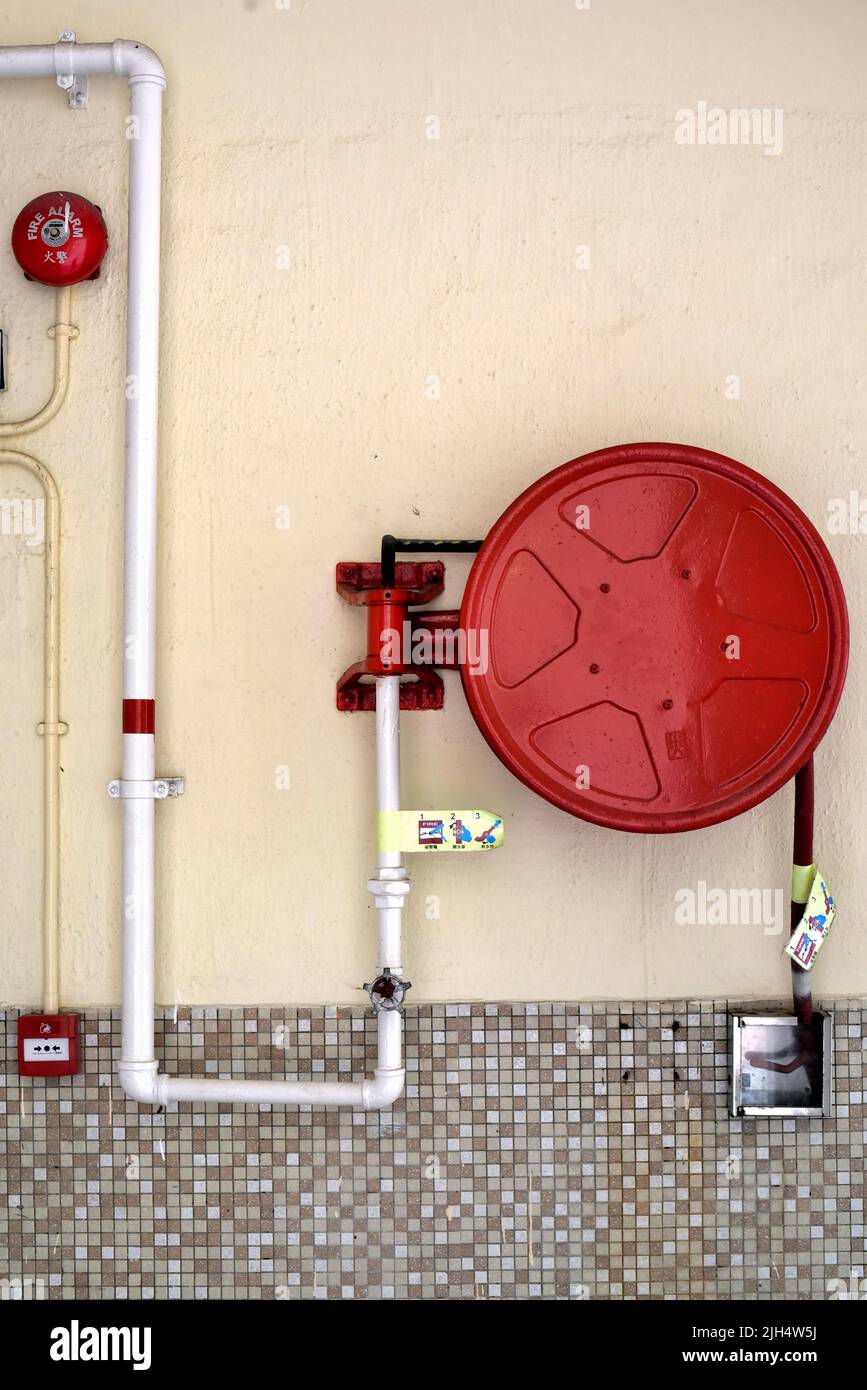 Wall mounted fire alarm and water hose system Stock Photo - Alamy