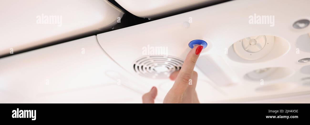 Airplane passenger female press blue button on plane with finger ...