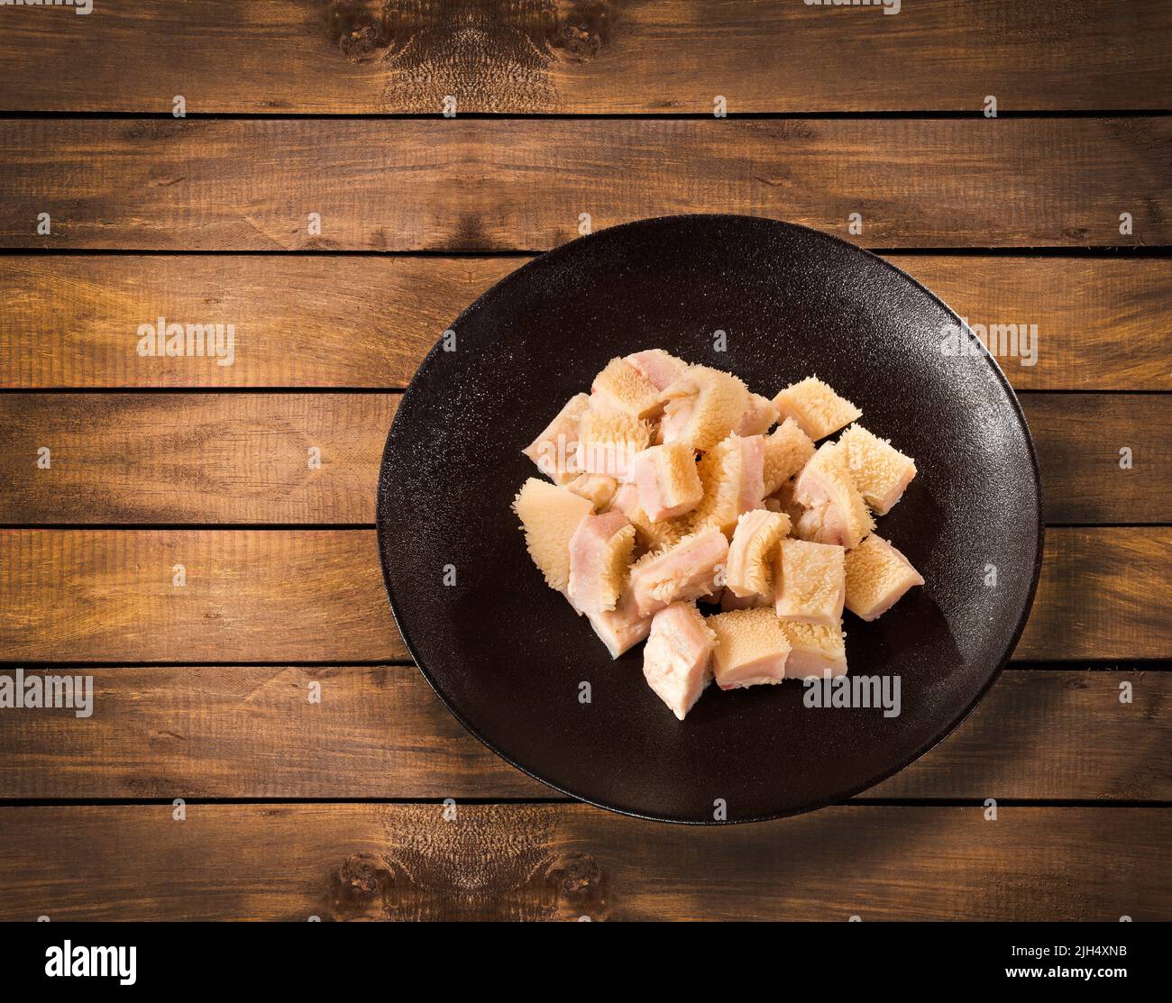 Raw chopped tripe on the plate - wooden background Stock Photo - Alamy