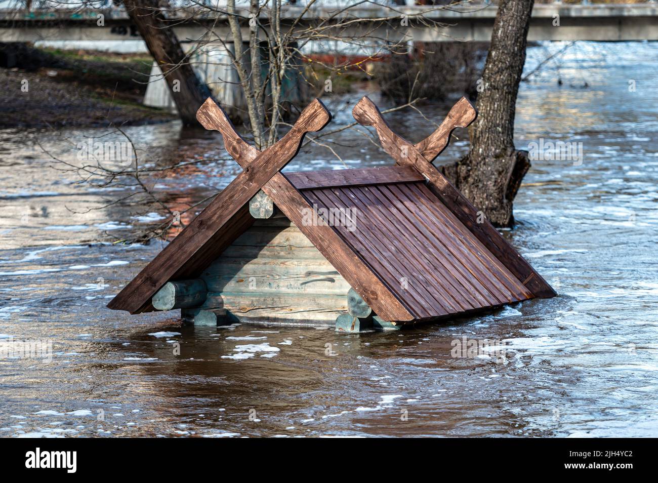 to the roof of a bird house flooded in spring floods - a feeder on the ...