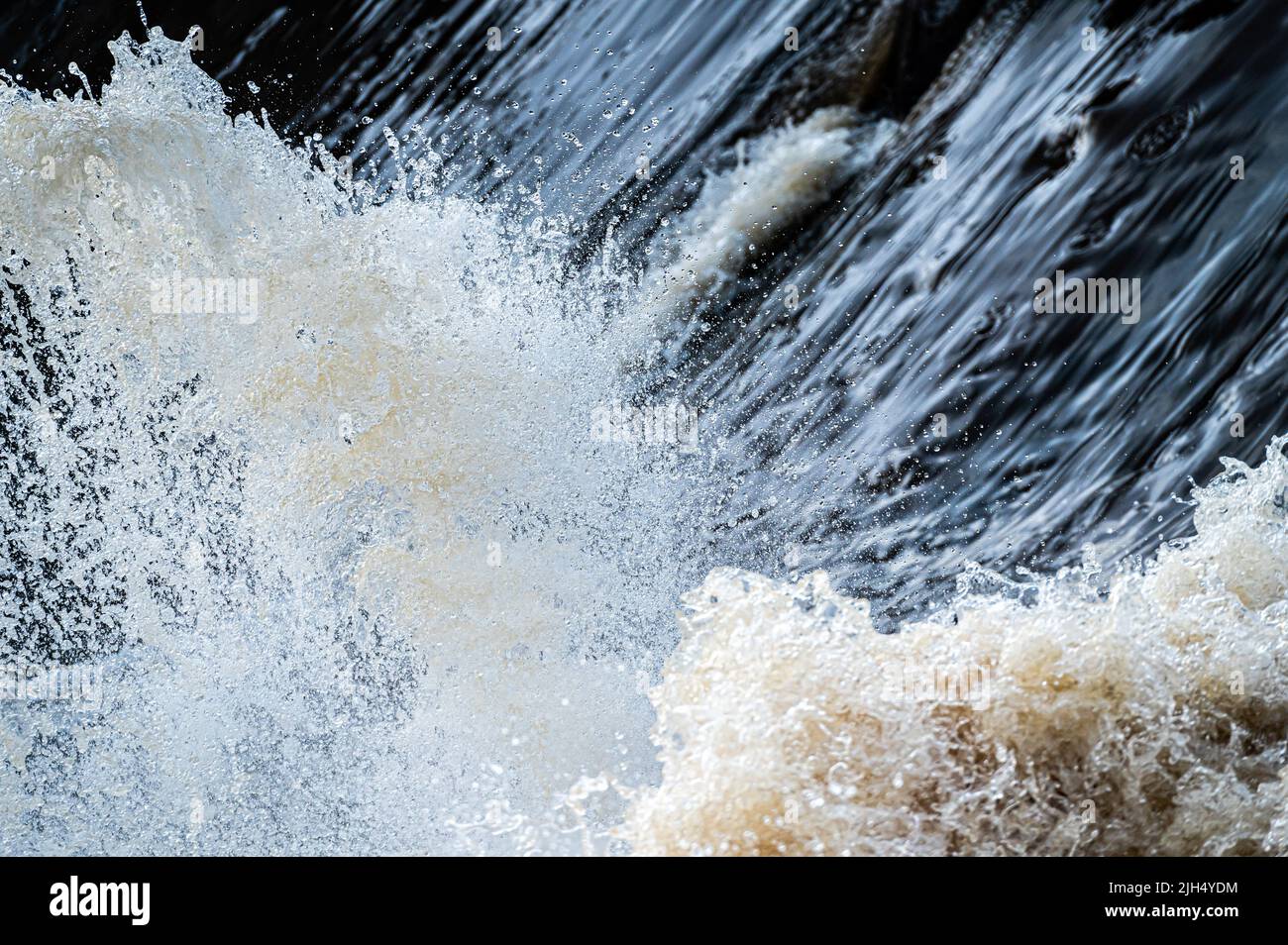 close-up of flowing water, rapid water splashes of an white water river ...