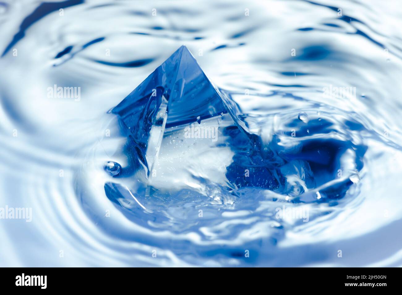 Abstract blue background with water splashen and a geometric object ...