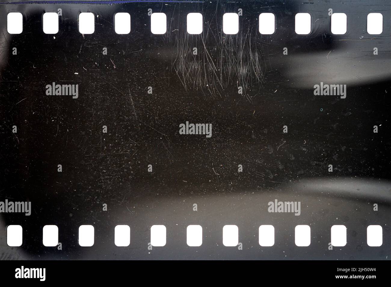 Dusty and grungy 35mm film texture or surface. Perforated scratched ...