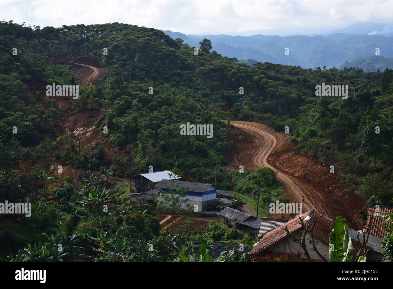 Motorcycles pass through the road in Cileuksa Village, Sukajaya, Bogor ...