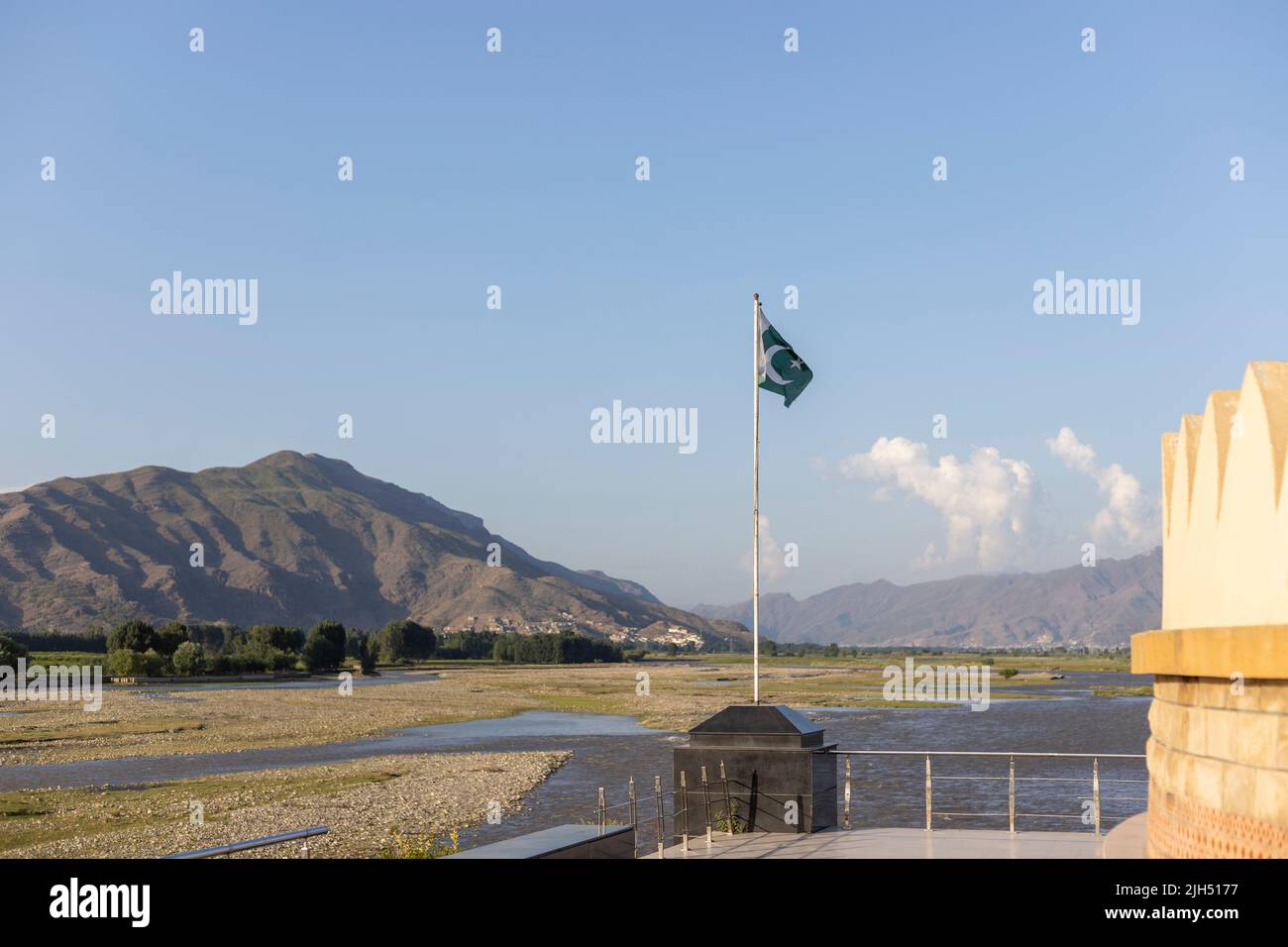 National Flag of Pakistan waving with a beautiful scenery in background ...