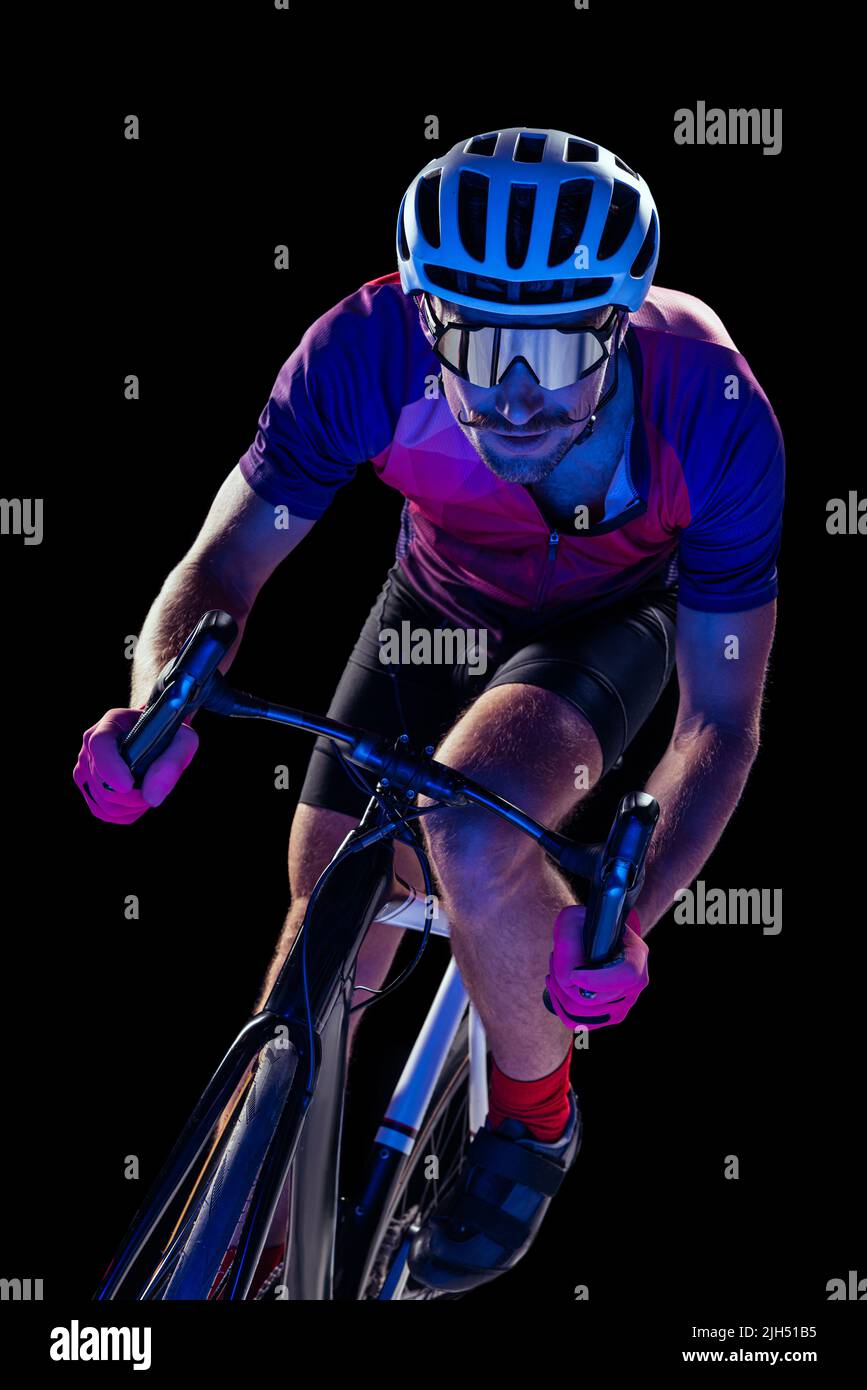 Portrait of man, professional cyclist training, riding isolated over ...