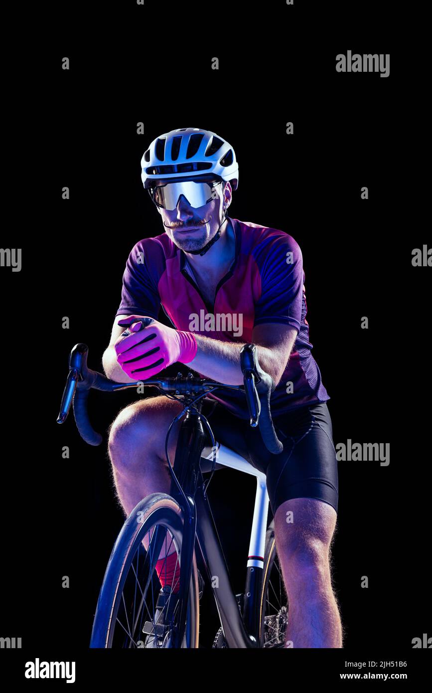 Portrait of man, professional cyclist training, riding isolated over ...