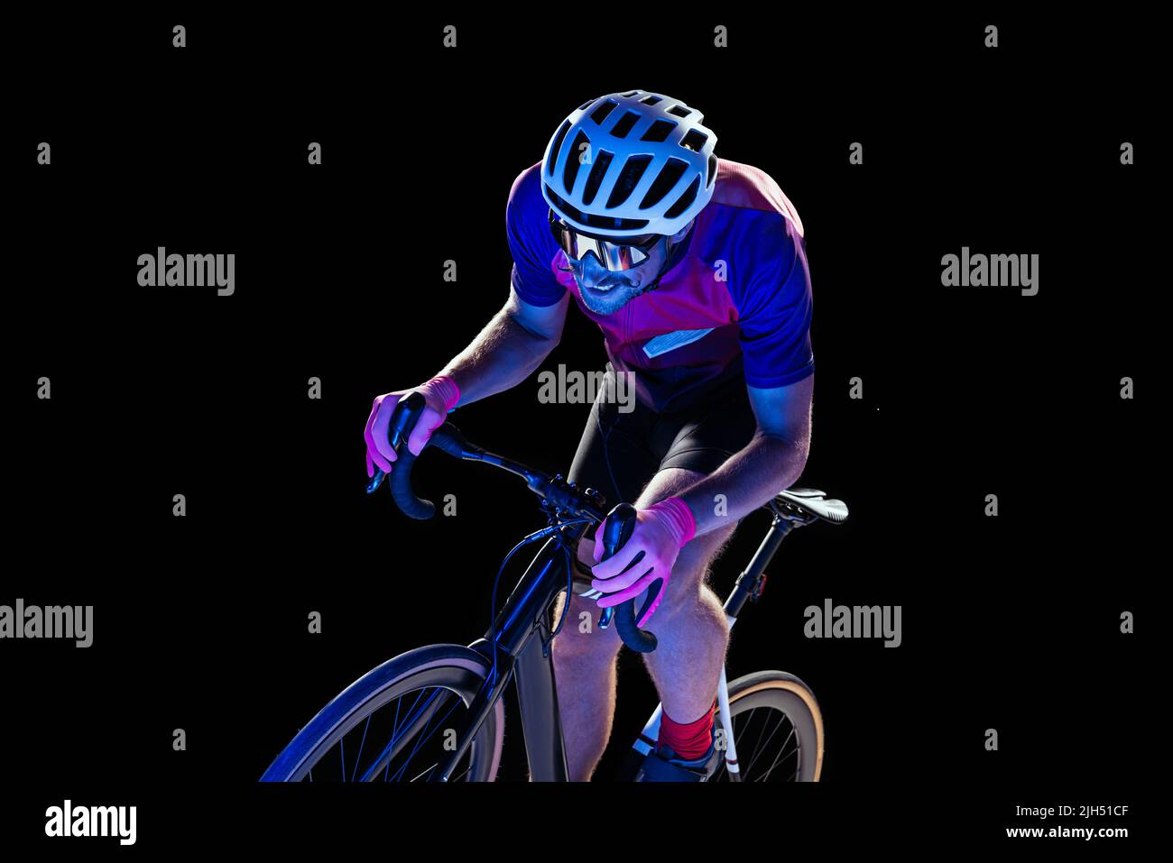Portrait of man, professional cyclist training, riding isolated over ...