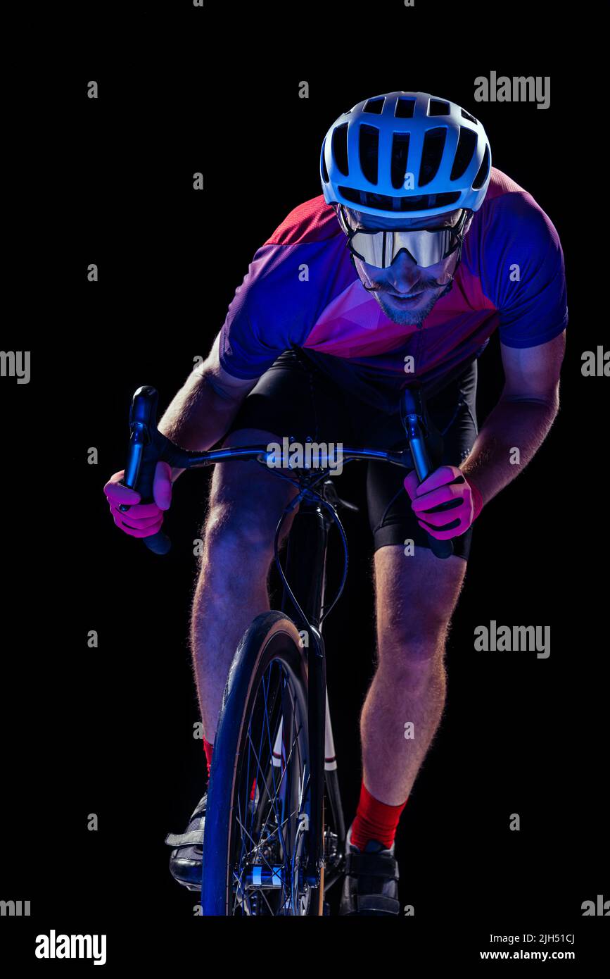 Portrait of man, professional cyclist training, riding isolated over ...