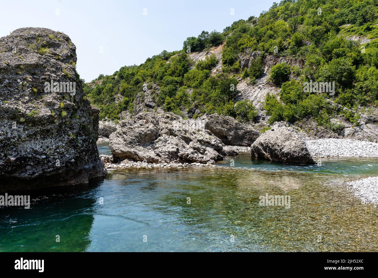 Low angle of view from river. We can see water and rock in river Stock ...
