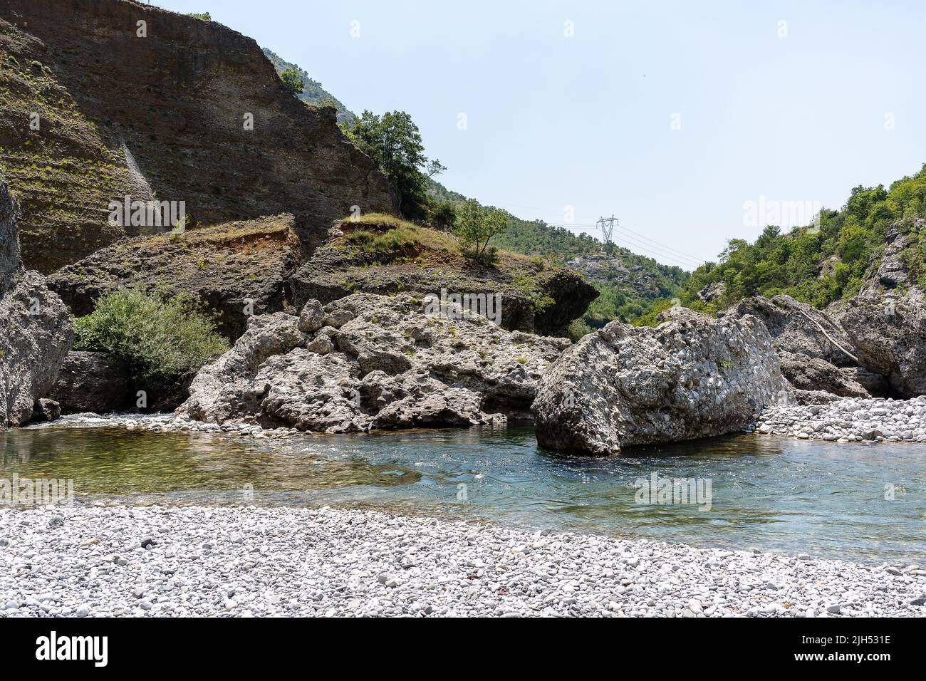 Low angle of view from river. We can see water and rock in river Stock ...