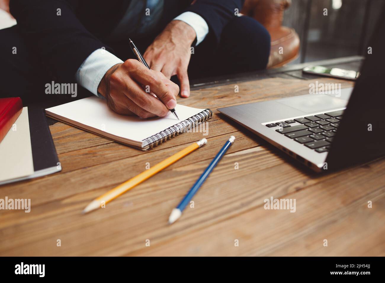 Male hands writing plans in notepad Stock Photo - Alamy