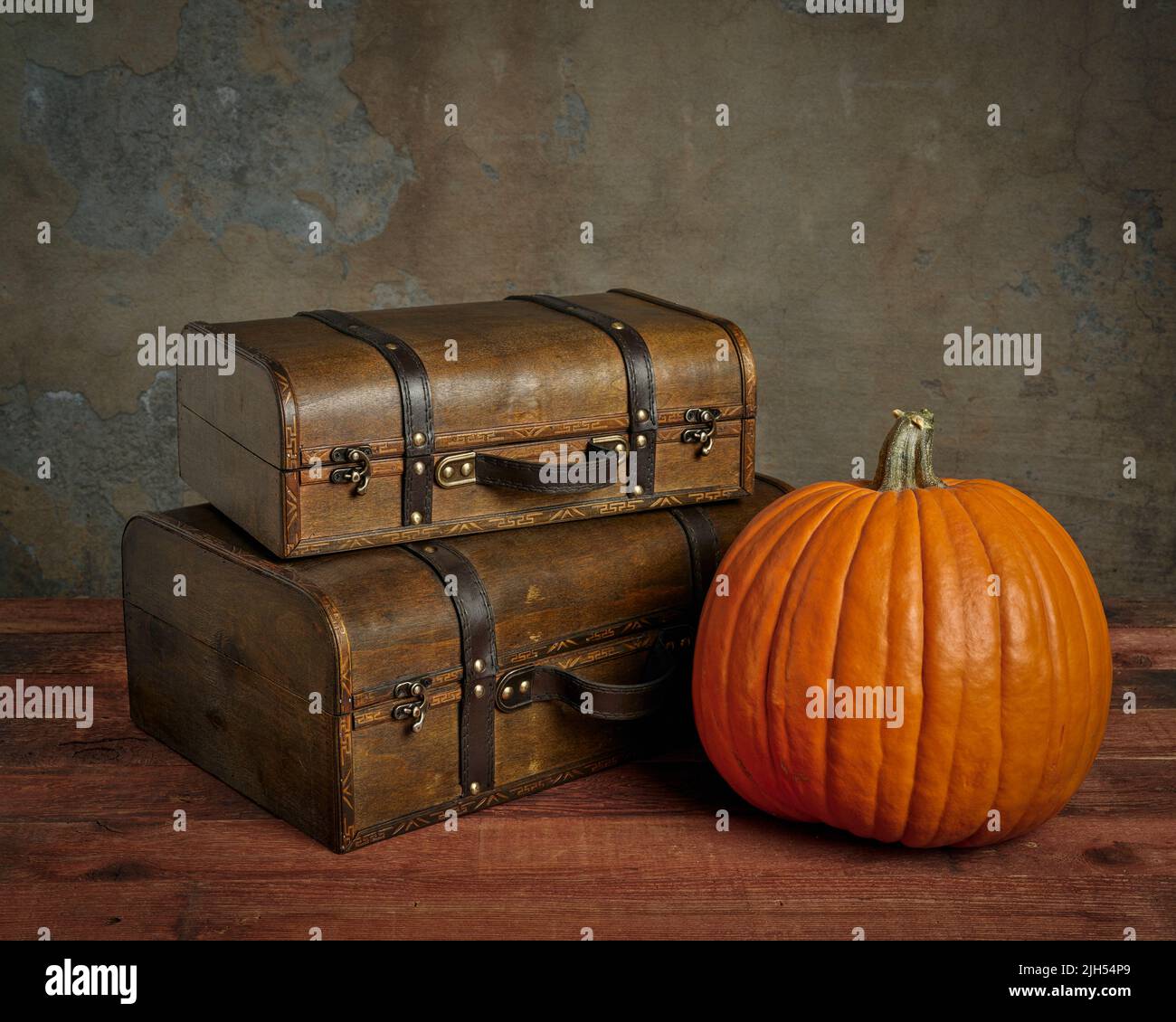 large pumpkin and small retro suitcases, fall holidays, Halloween or ...