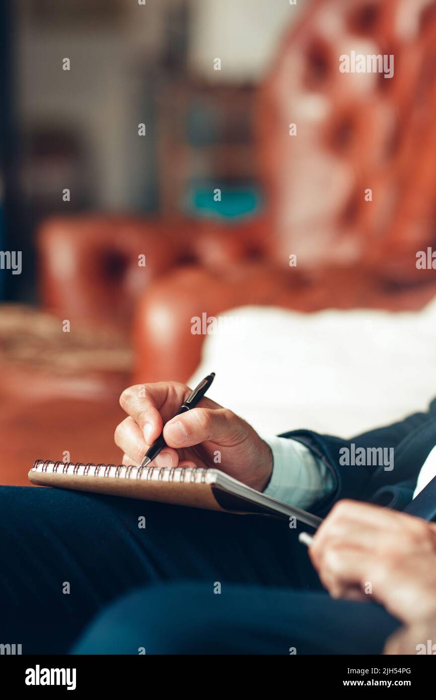 Male hand writing plans in a notepad Stock Photo - Alamy