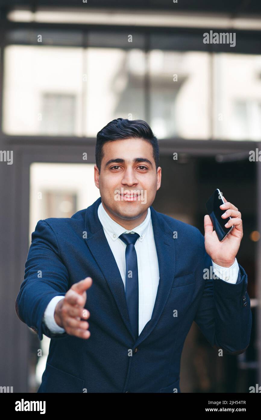 Young man giving a hand for handshake Stock Photo - Alamy
