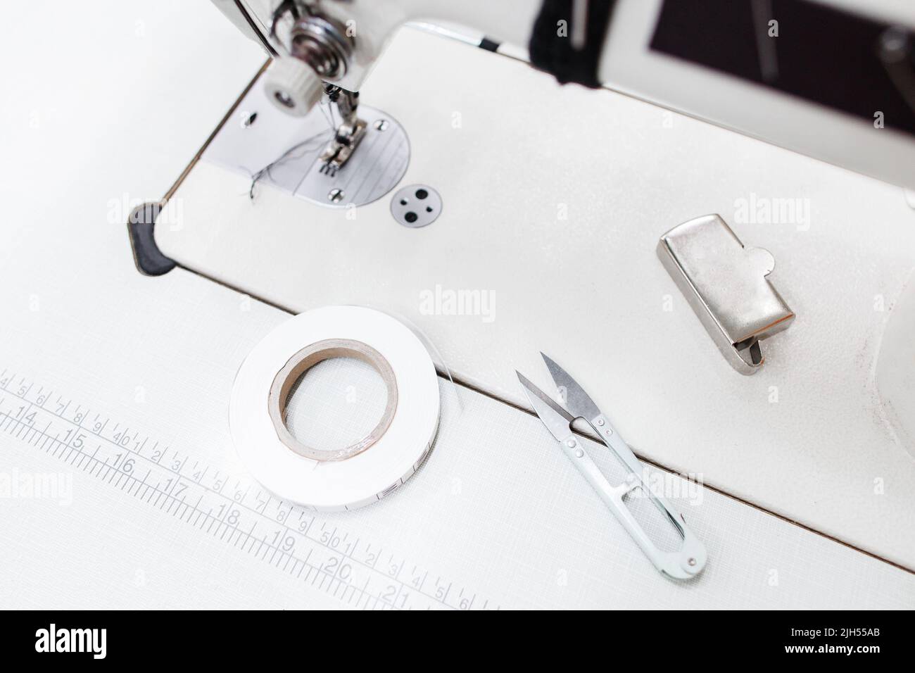 Sewing machine platform with supplies top view Stock Photo - Alamy