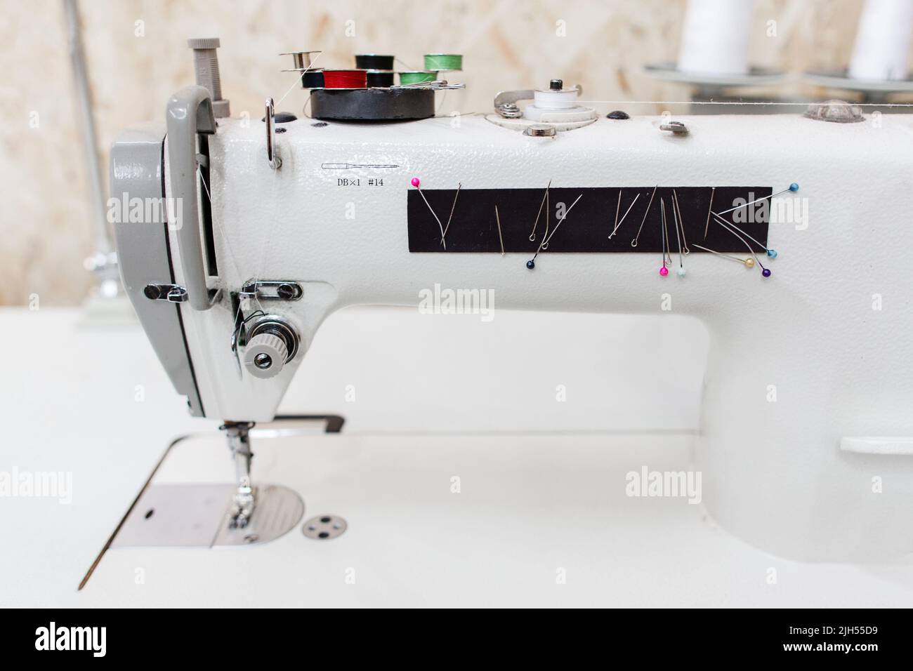 Sewing machine with colorful needles side view Stock Photo - Alamy