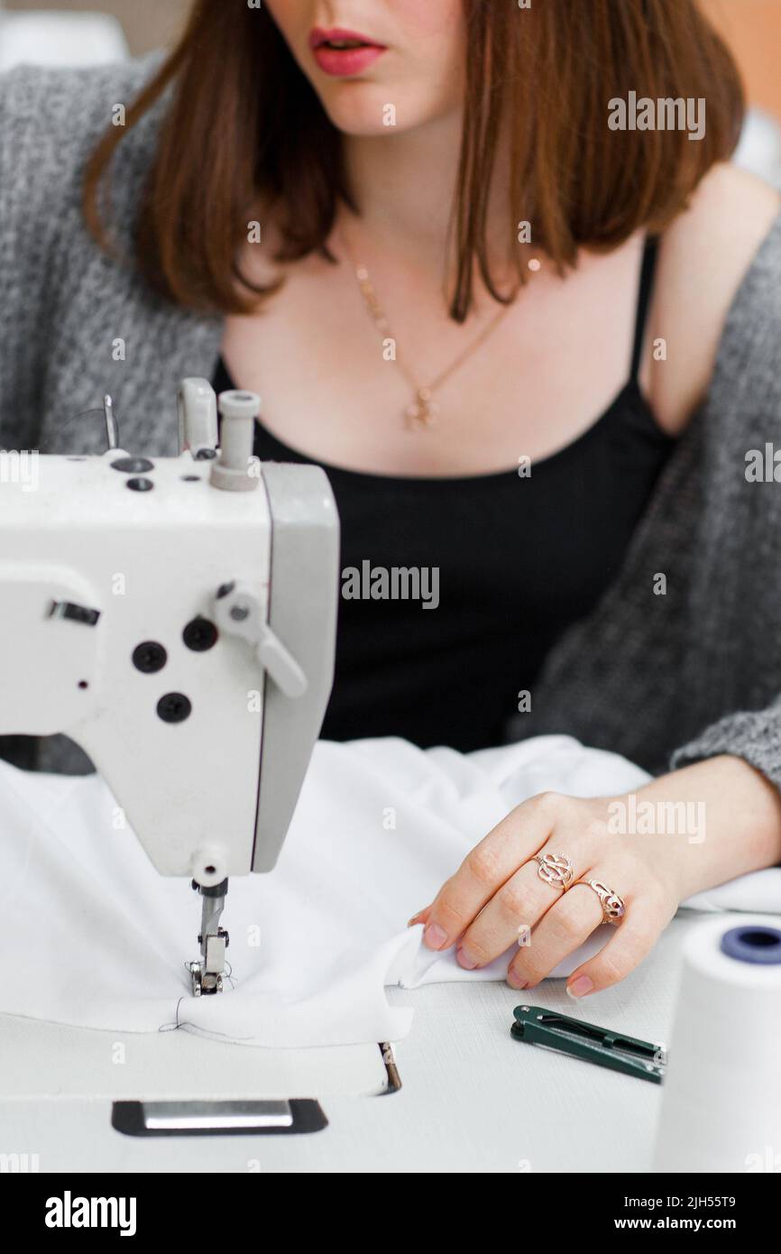 Woman sitting sewing machine hi-res stock photography and images - Alamy